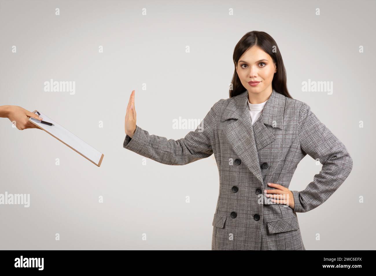 Resolute woman refusing document with hand up Stock Photo - Alamy