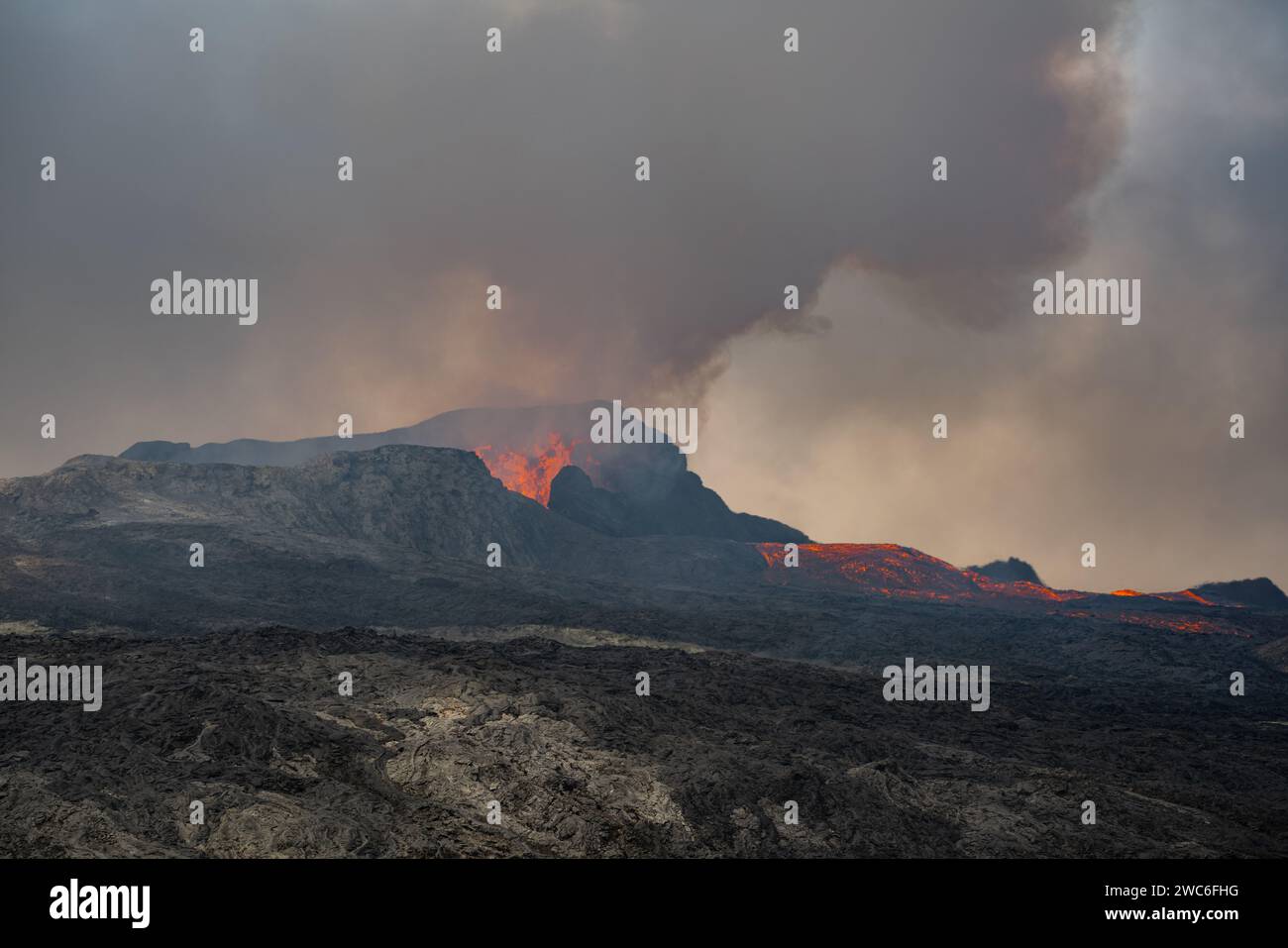 View across a hardened black grey lava field. Through shimmering hot ...