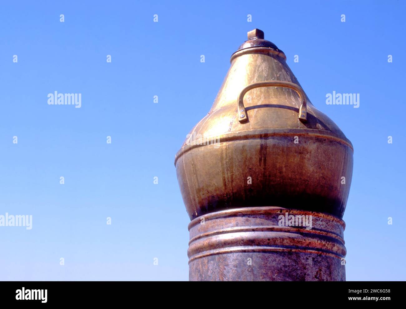 Metal pot to prepare bean dish on a fire, in use in the Middle East ...