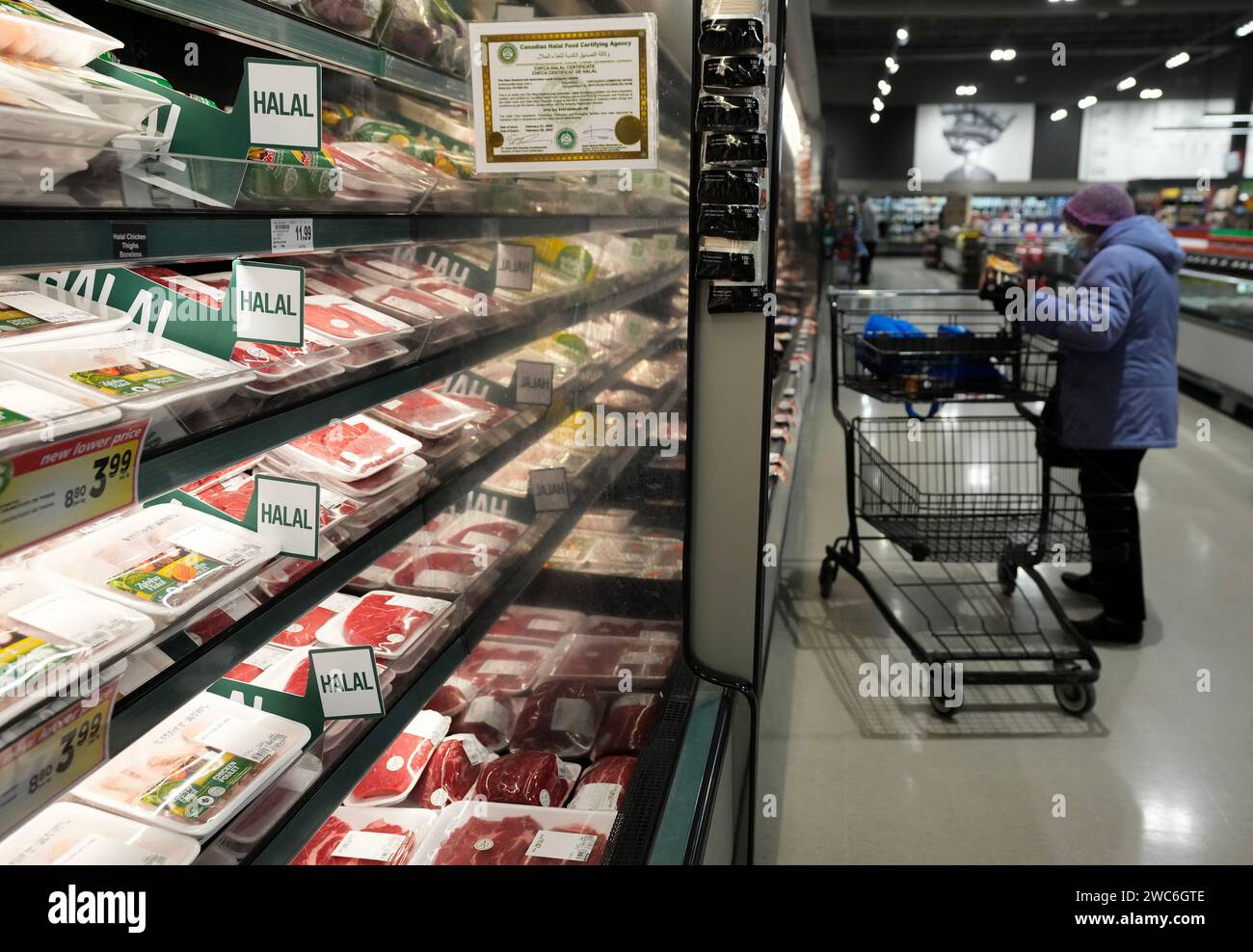 People walk past the halal food section inside a Metro grocery store in ...