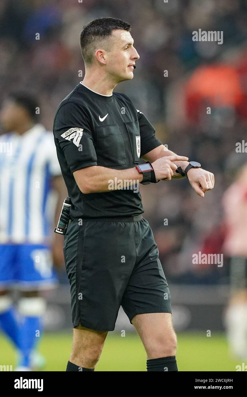 Referee Lewis Smith checks his watch during the Southampton FC v ...