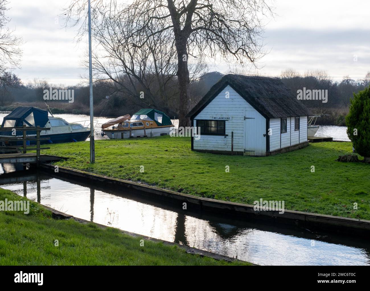 Coltishall, Norfolk, UK – January 13 2024. Boats moored near a wooden ...