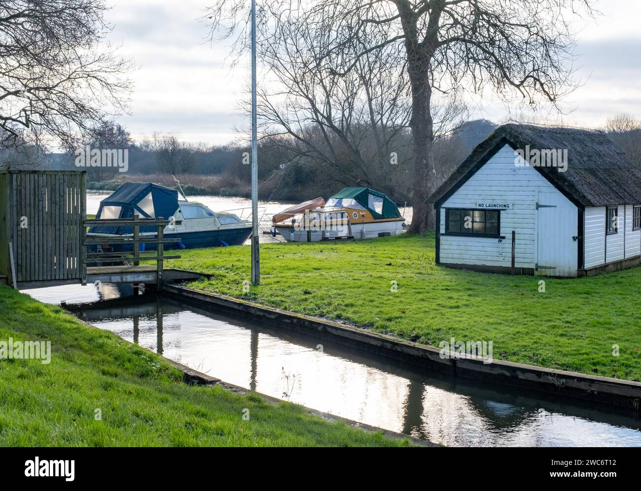Coltishall, Norfolk, UK – January 13 2024. Boats moored near a wooden ...