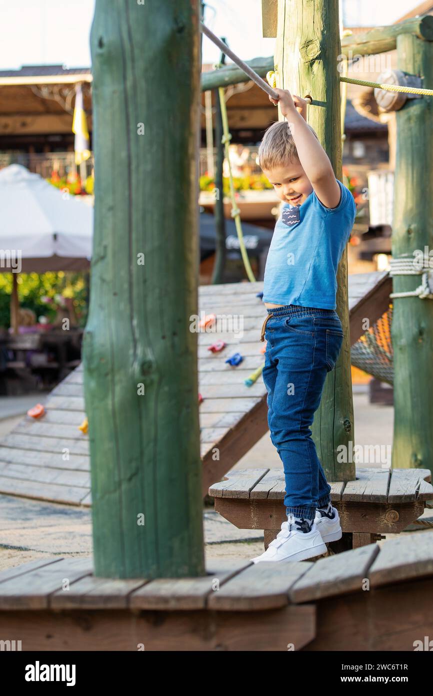 A happy child completed an obstacle course on an eco-friendly wooden ...