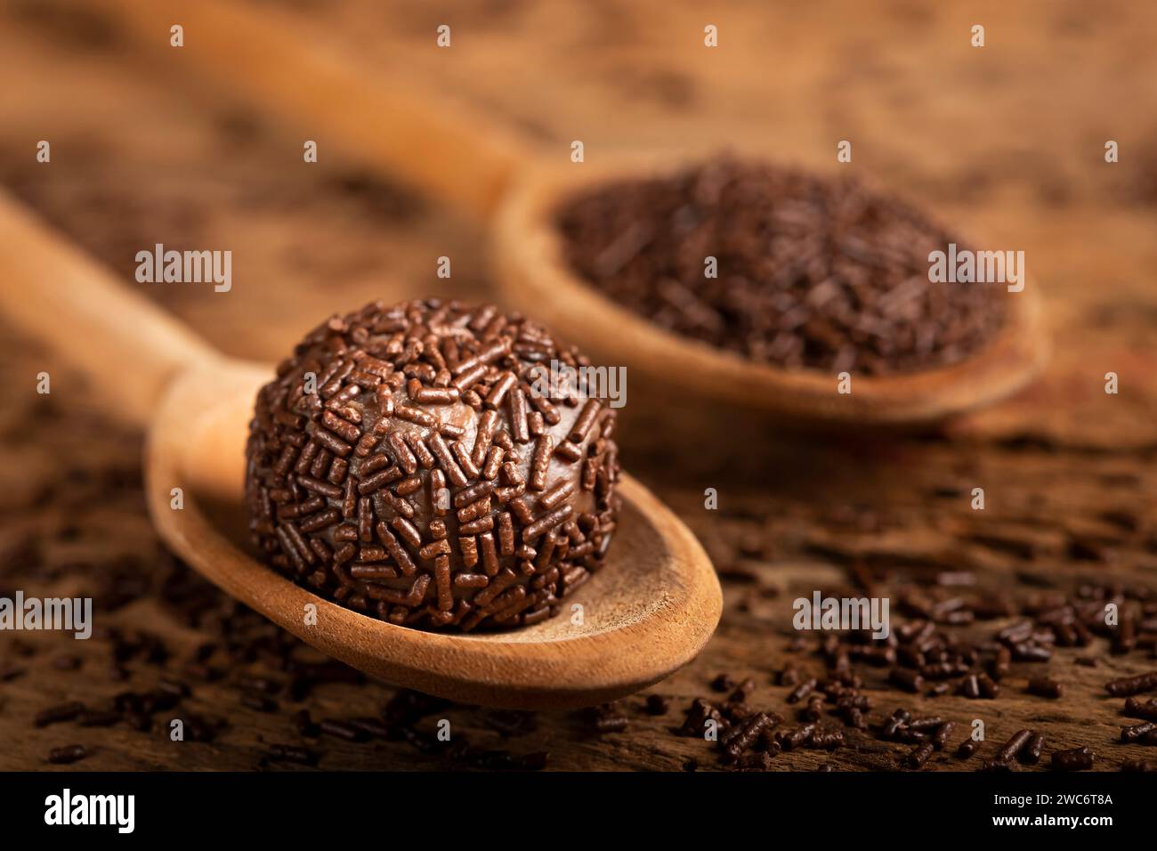 Chocolate brigadeiro in wooden spoon. Brigadeiro, traditional Brazilian ...