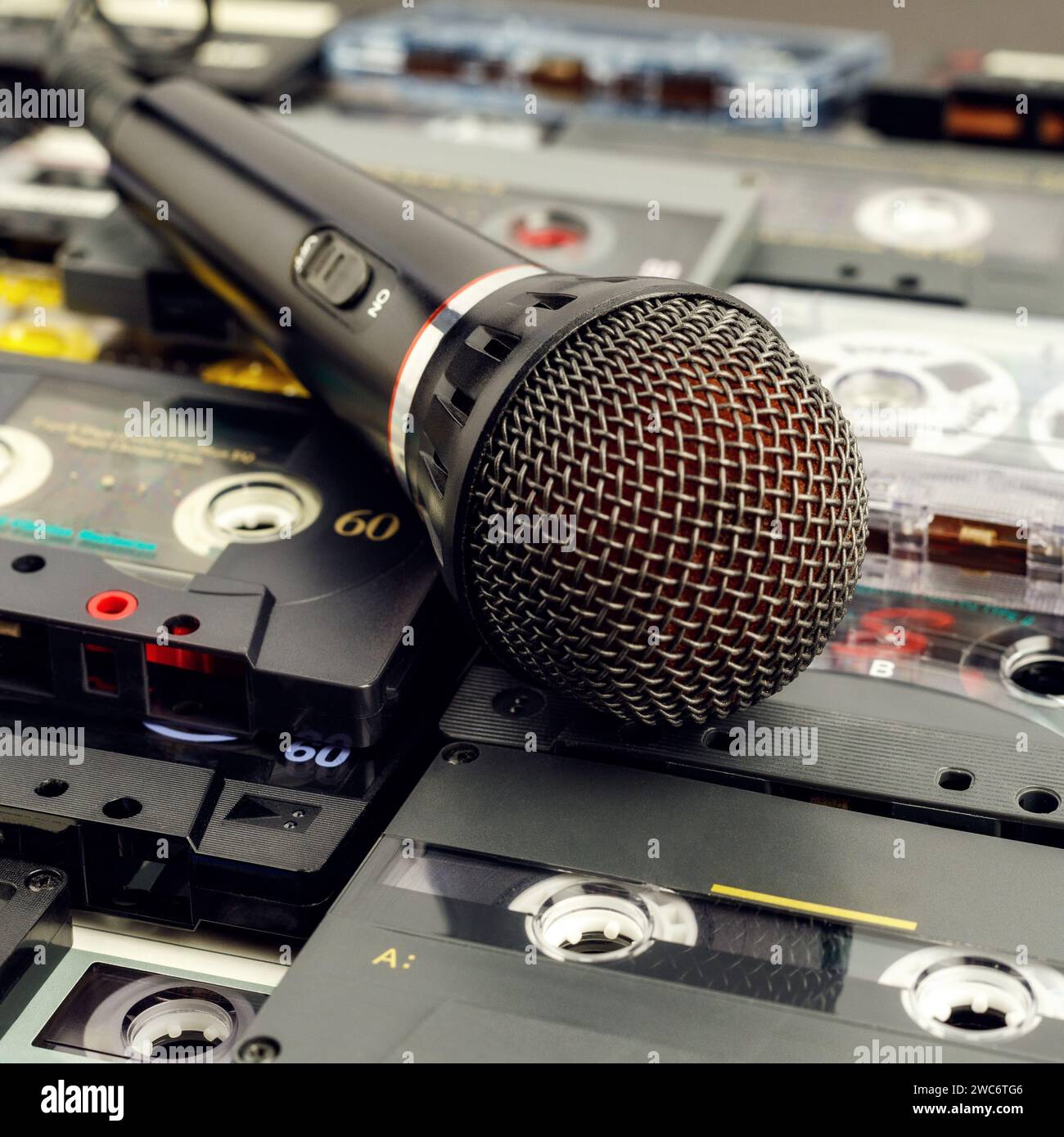 Square photo with a microphone close-up on a background of old audio ...