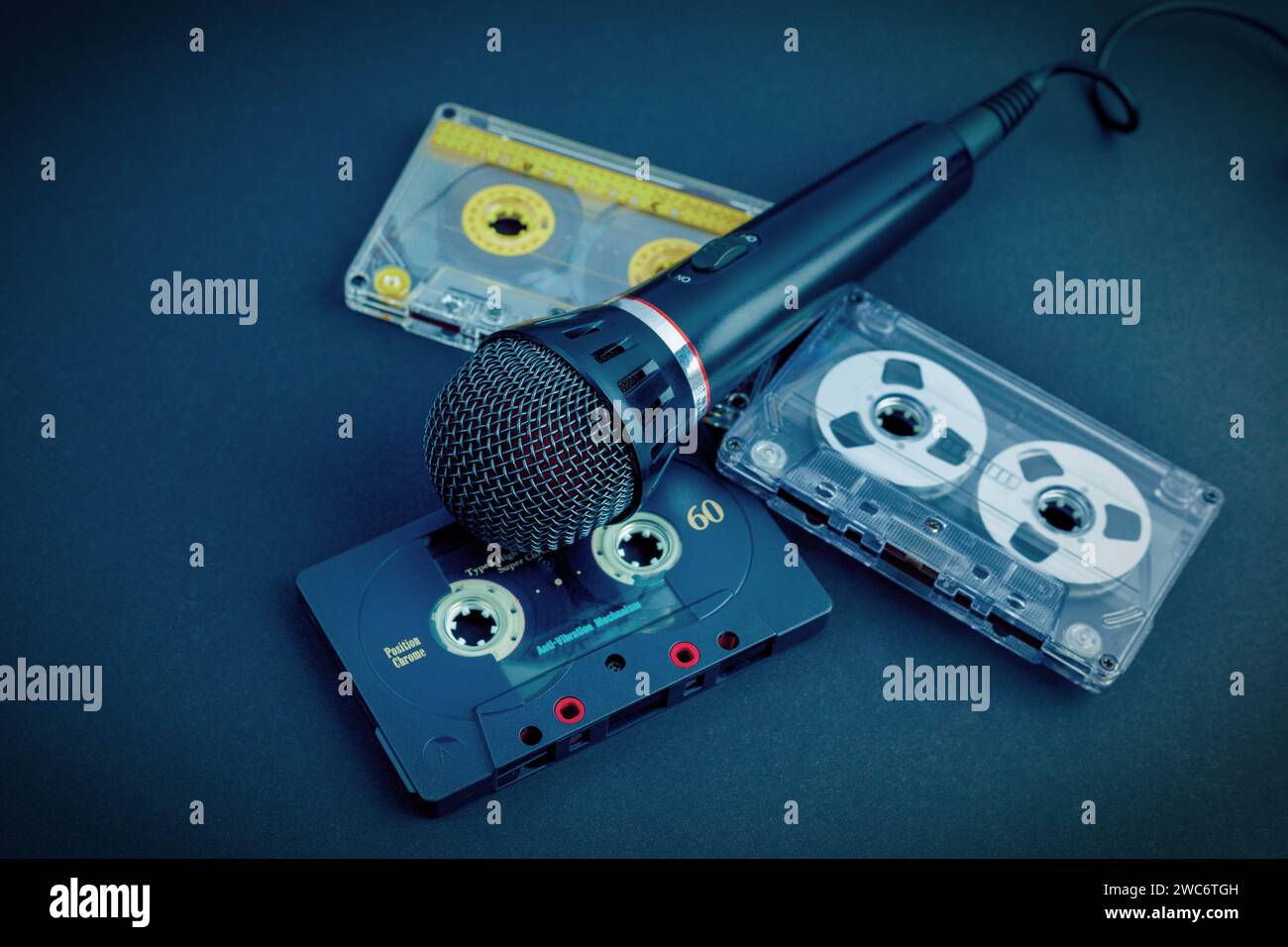 Black professional karaoke microphone and three colorful vintage audio ...