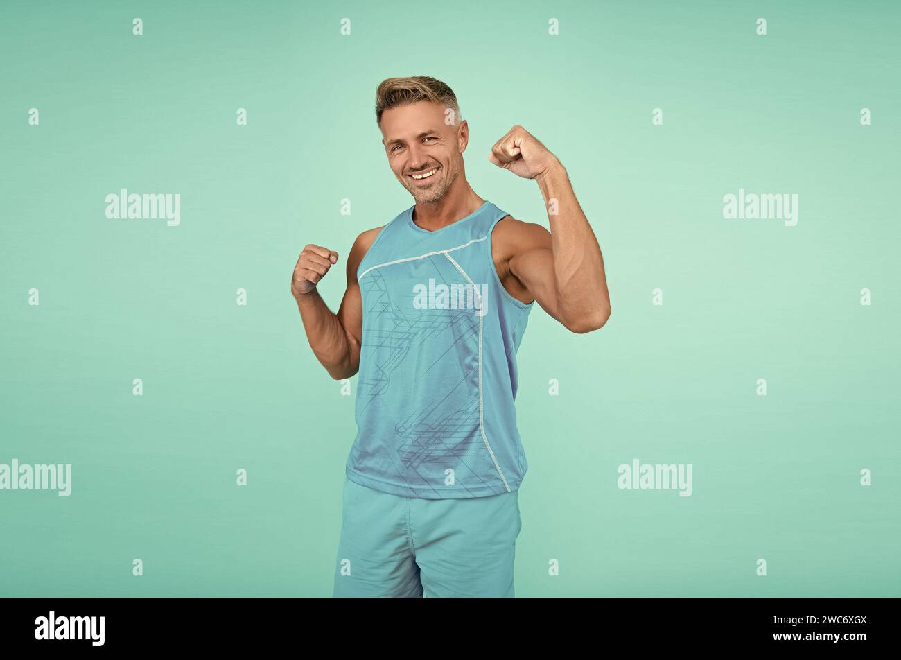 Happy sport athlete making winning gesture. athlete winner blue ...