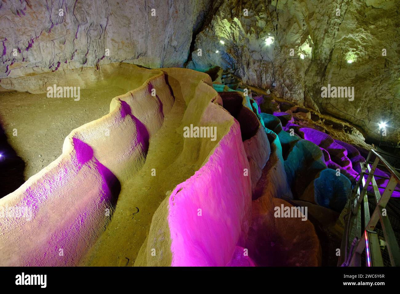 cave formation, undulating rimstone-pools inside illuminated Stopica ...