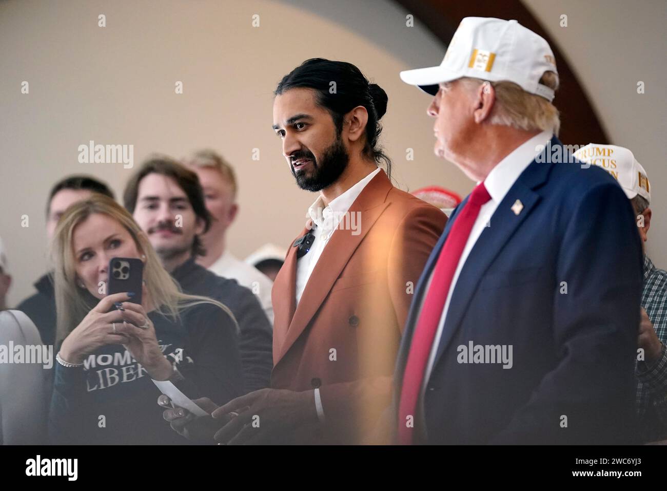 Republican presidential candidate former President Donald Trump listens ...