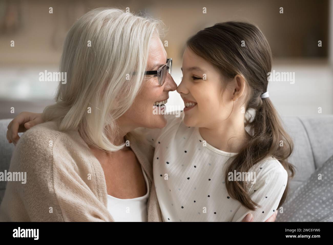 Happy senior grandma and cute grandkid hugging, laughing, enjoying ...