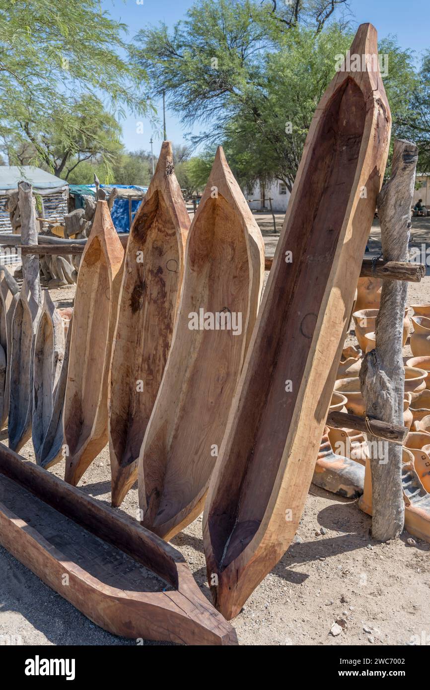 wooden pirogues on sale at crafts market, shot in bright late spring ...