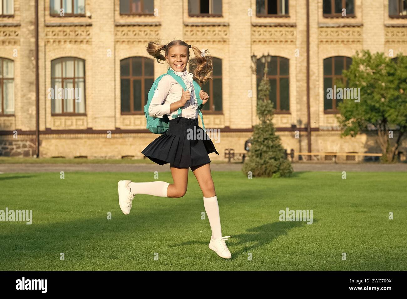 Happy teen girl running to school. Energetic schoolgirl carrying school ...