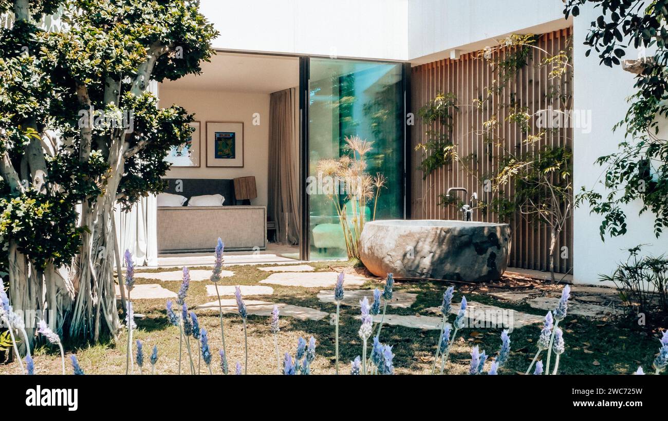 A beautifully landscaped garden surrounds a charming house, showcasing ...