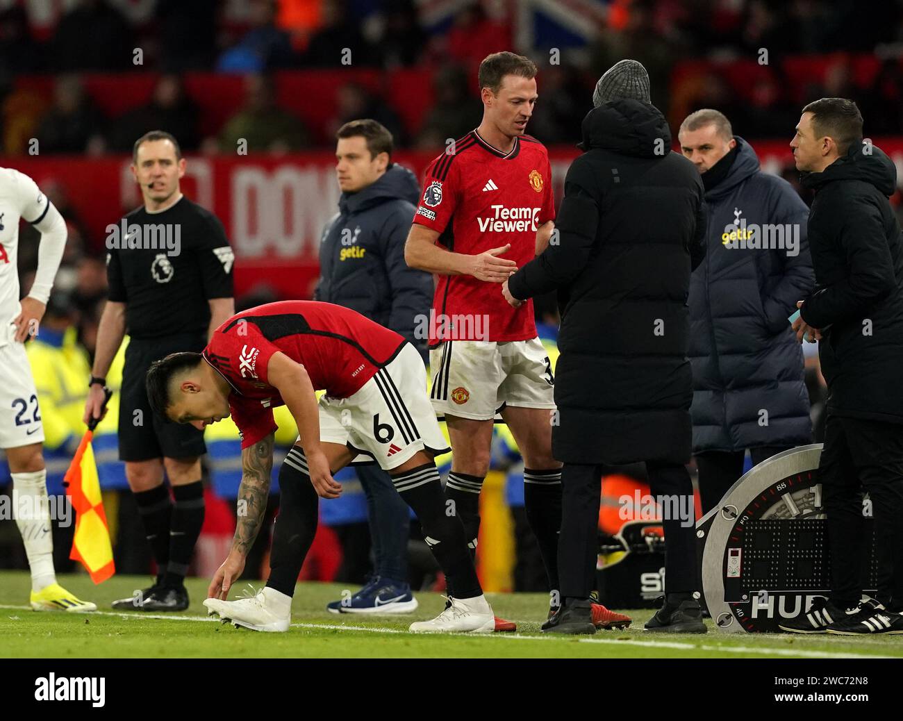 Manchester United's Jonny Evans shakes hands with manager Erik ten Hag ...