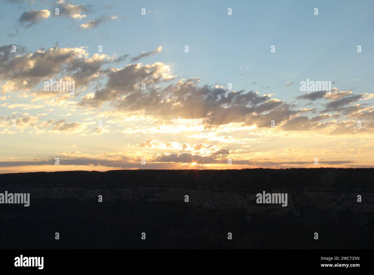 This photo shows the sunlight emerging through the clouds during sunset ...