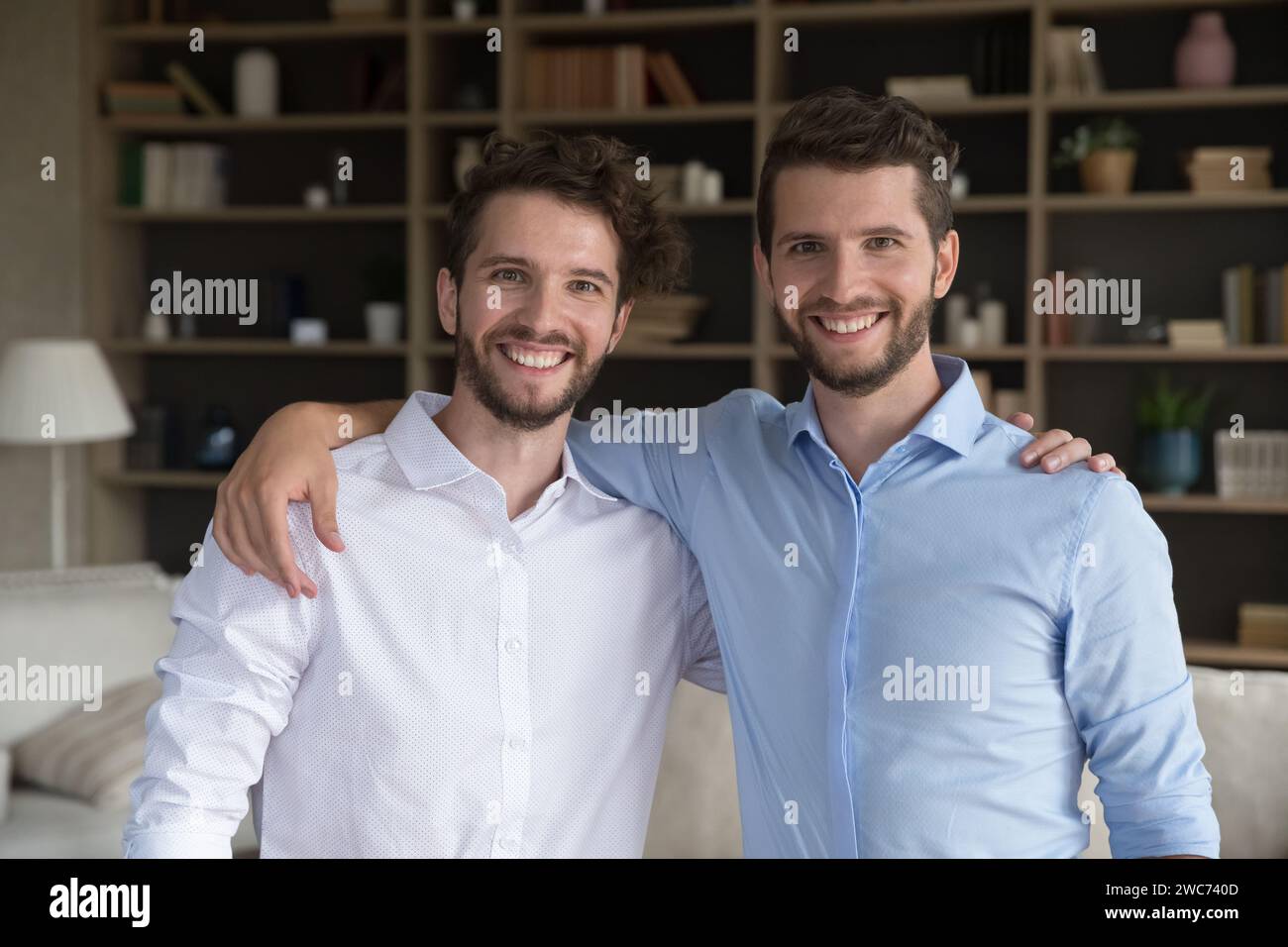 Portrait of two millennial twin brothers posing in living room Stock ...