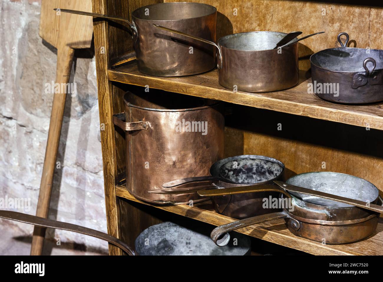 Vintage copper pans stand on wooden shelving Stock Photo - Alamy