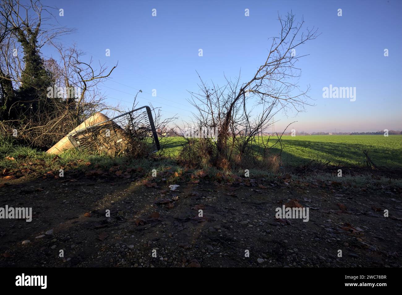 Garbage by the edge of a path Stock Photo - Alamy