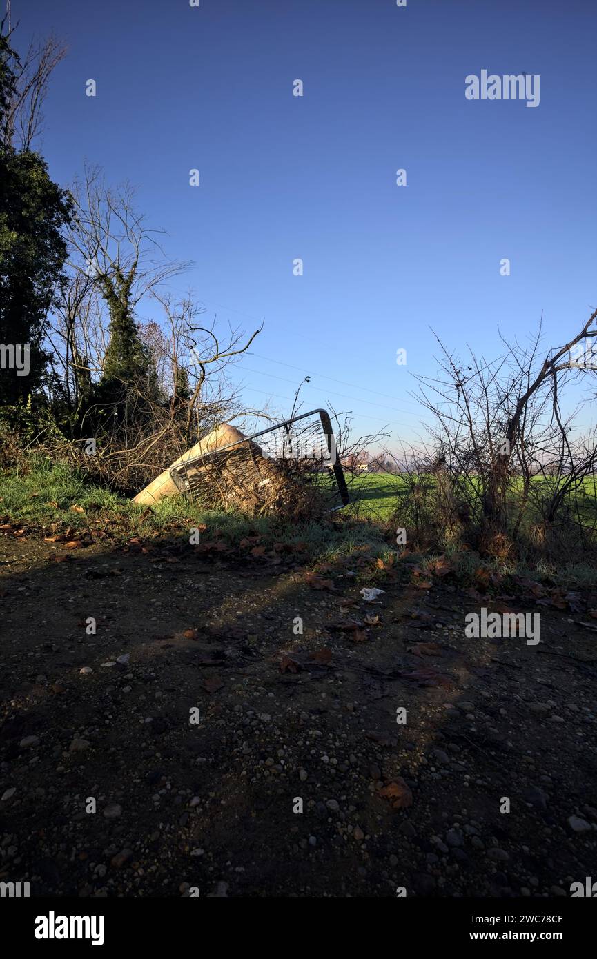 Garbage by the edge of a path Stock Photo - Alamy