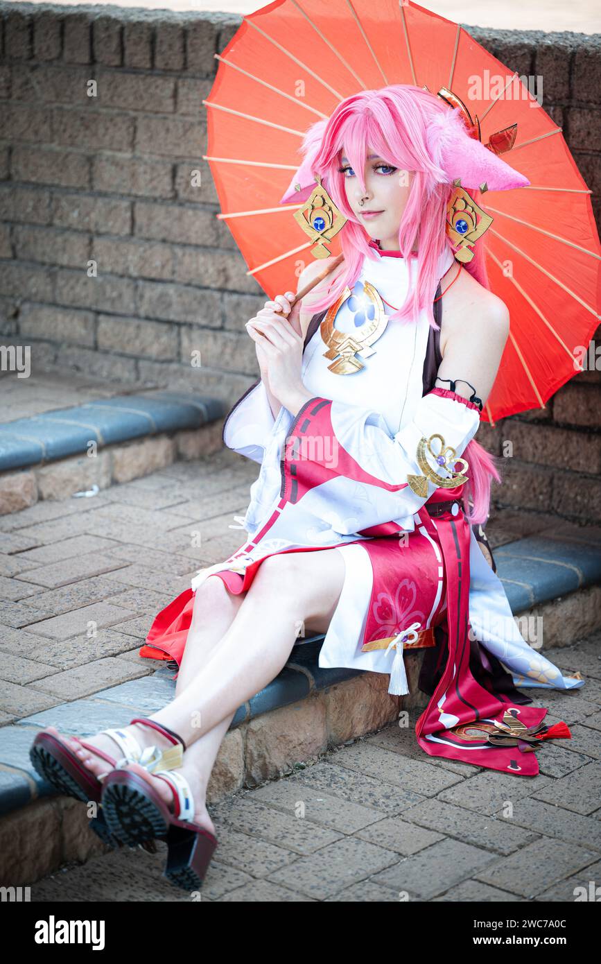 A Female cosplayer in a pink anime costume wearing pink hair Stock ...