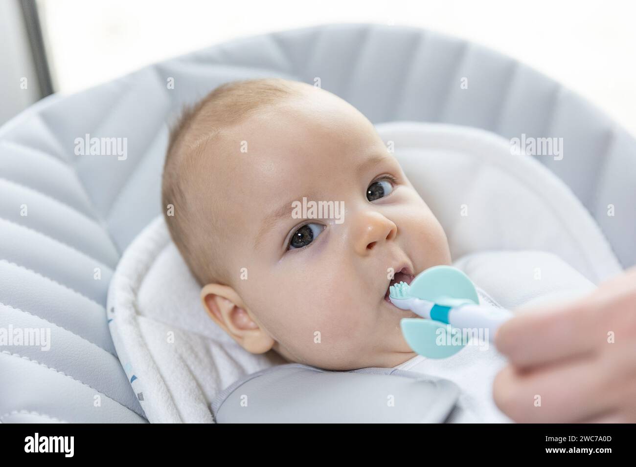 Newborn baby suffering of his tooth growth, mom using a teether to ease ...