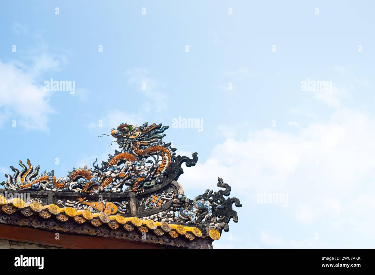 A traditional dragon sculpture, intricately detailed, sits atop an ...