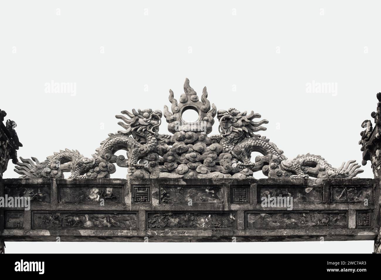 Intricate stone dragon and cloud carvings adorning an ancient tomb gate ...