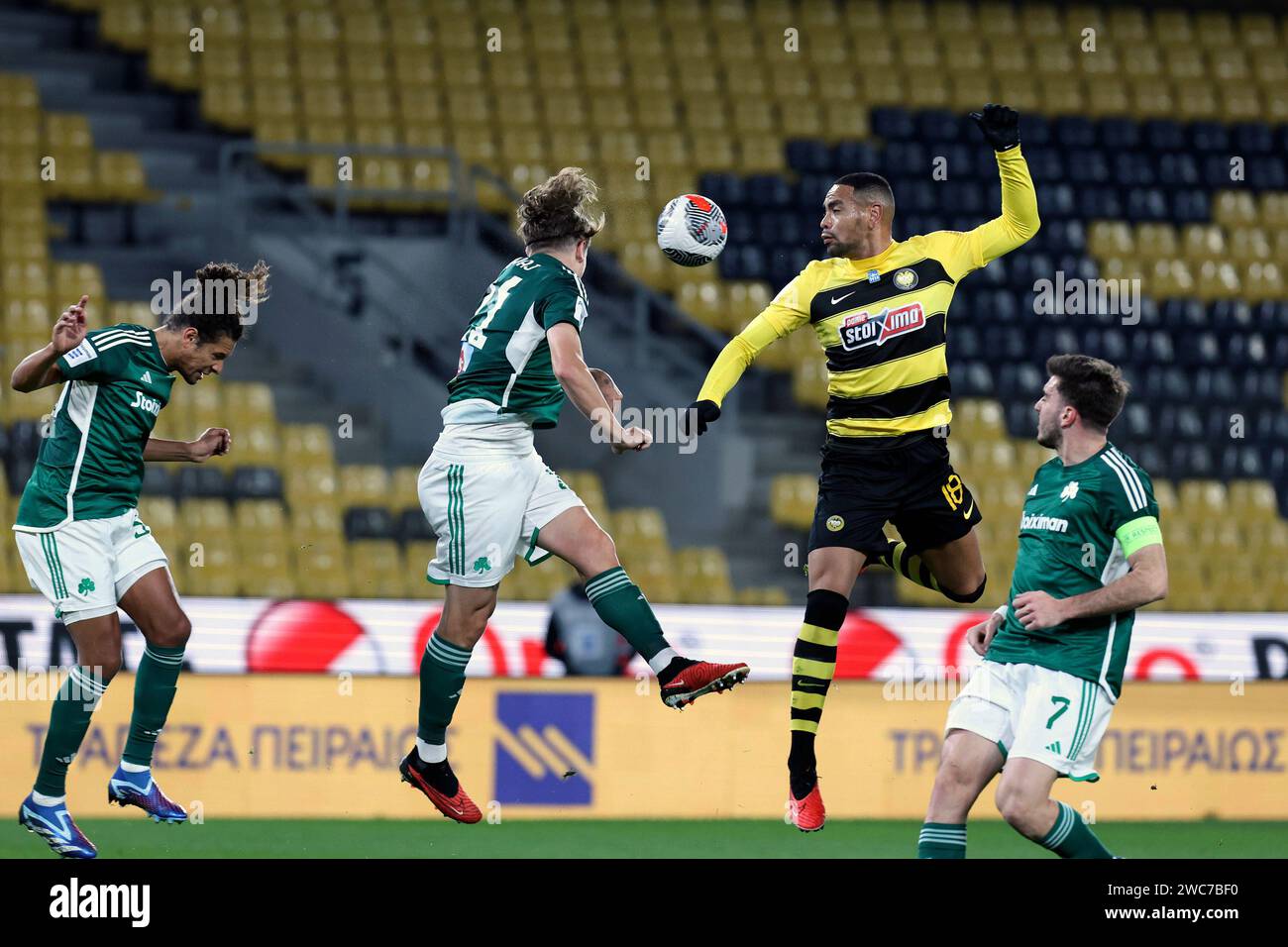 AEK Athens' Alexander Callens, right, fights for the ball against ...