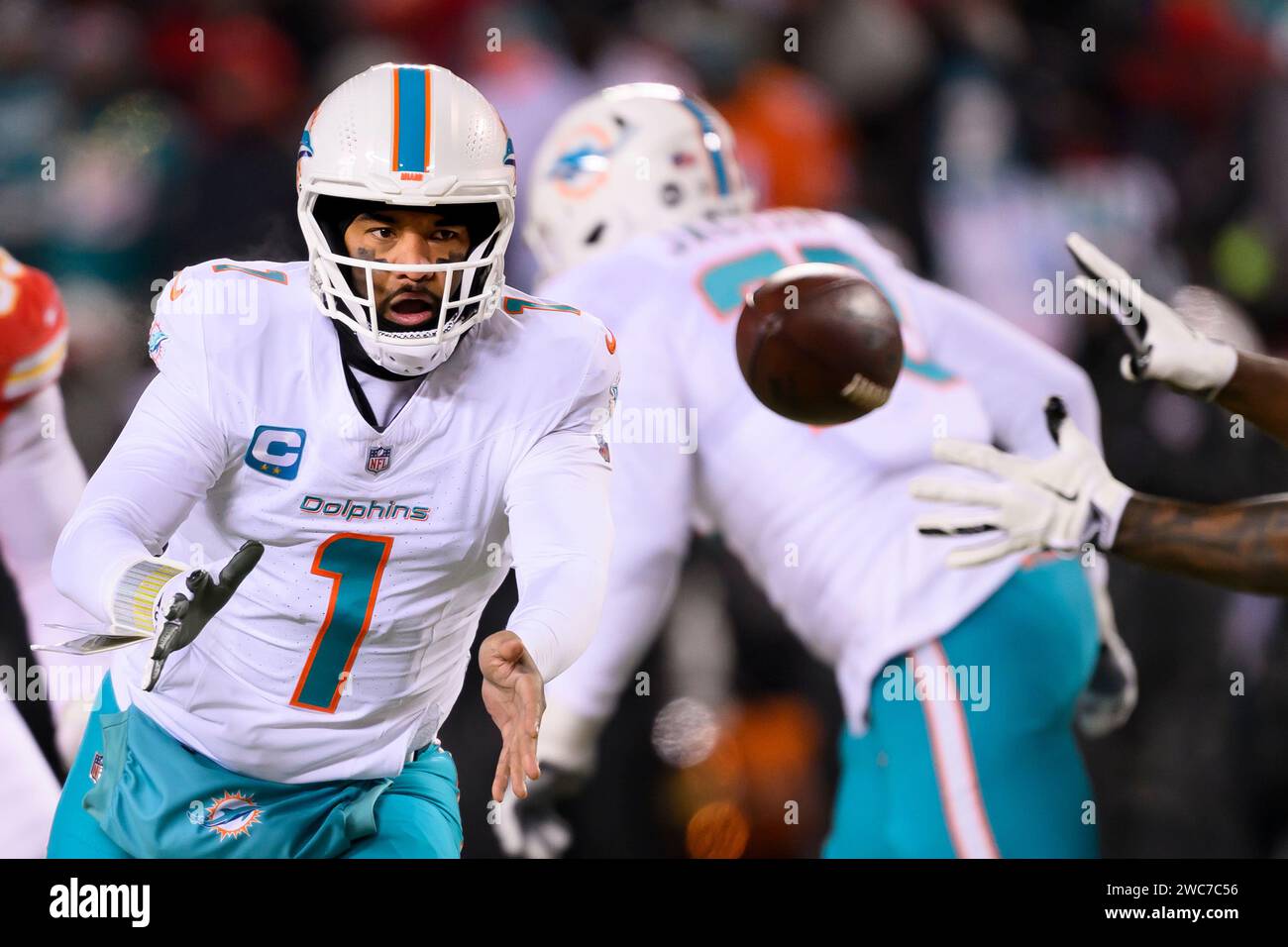 Miami Dolphins quarterback Tua Tagovailoa tosses the ball to Miami ...