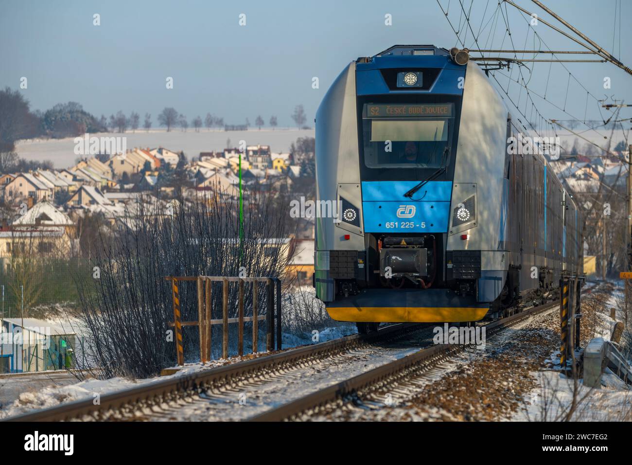 Blue electric trains near railway stop in cold sunny day in Hrdejovice ...