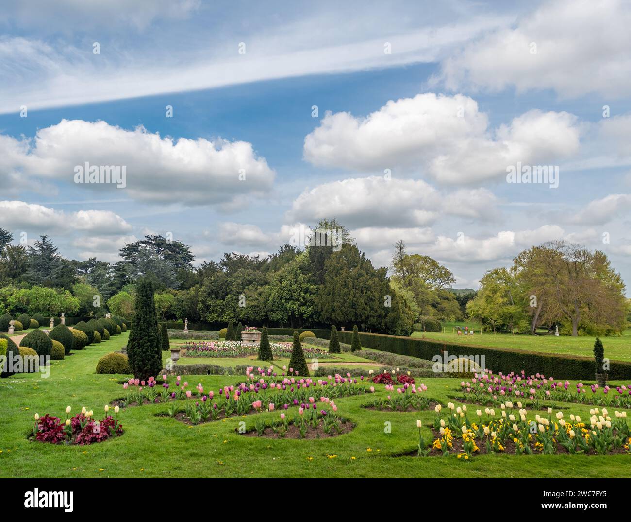A beautifully manicured lawn adorned with vibrant flowers at its center ...