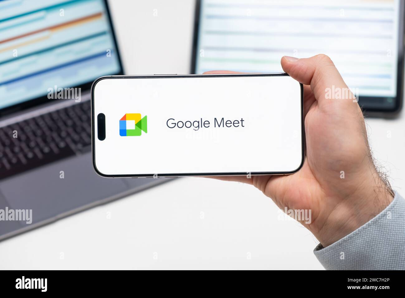 Google Meet logo of app on the screen of mobile phone held by man in ...