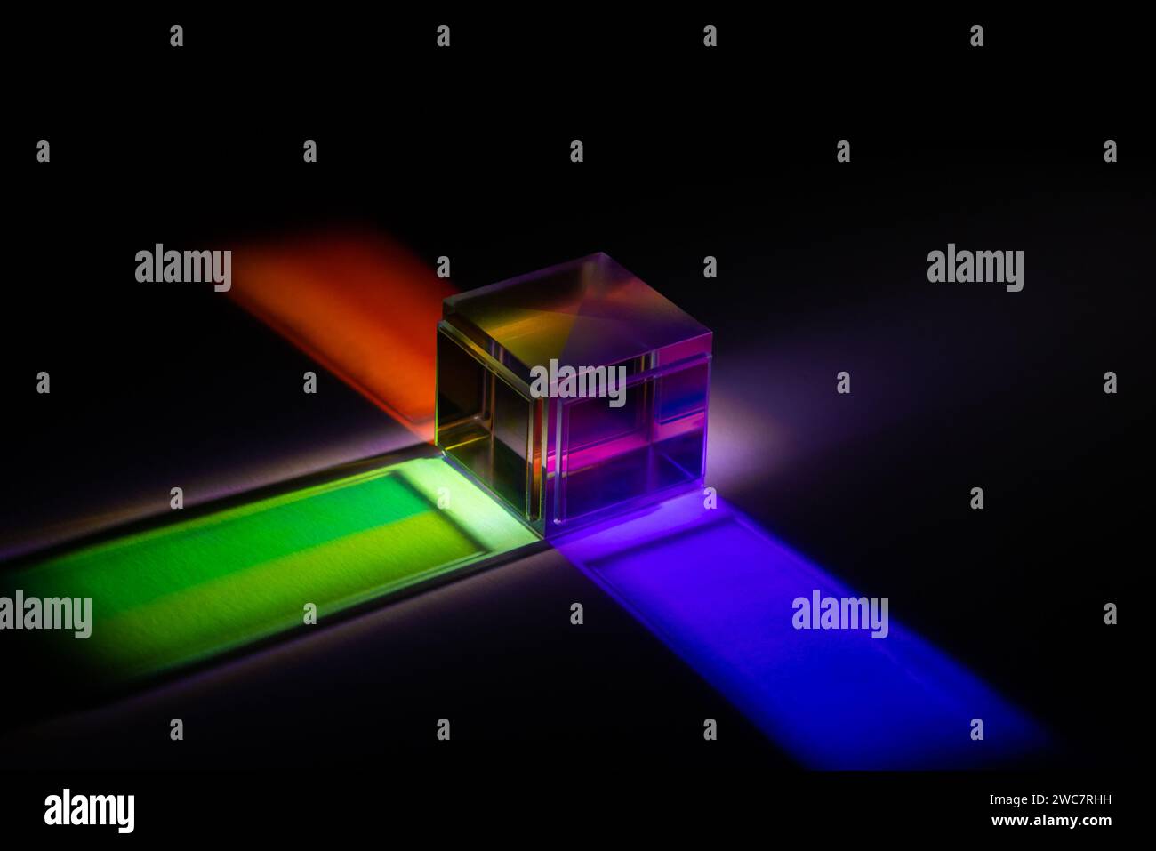 Spectral decomposition of a light ray into colors. A glass cube ...