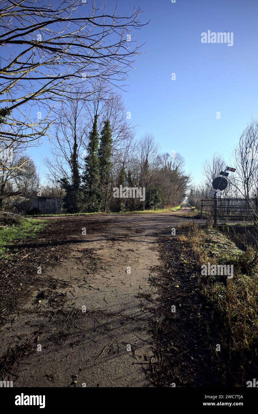 Crossroads between a dirt path and a bridge Stock Photo - Alamy