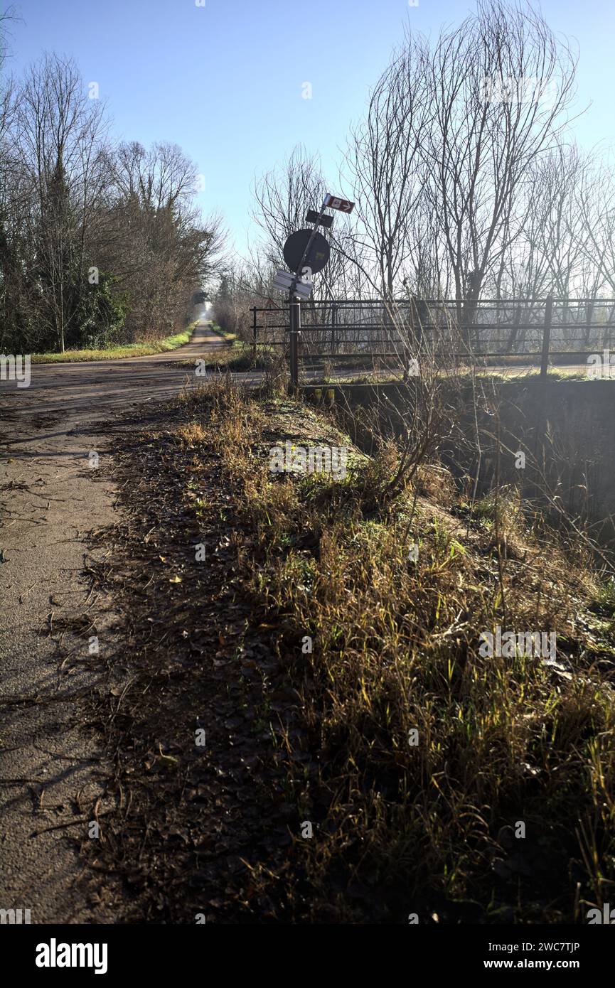 Crossroads between a dirt path and a bridge Stock Photo - Alamy