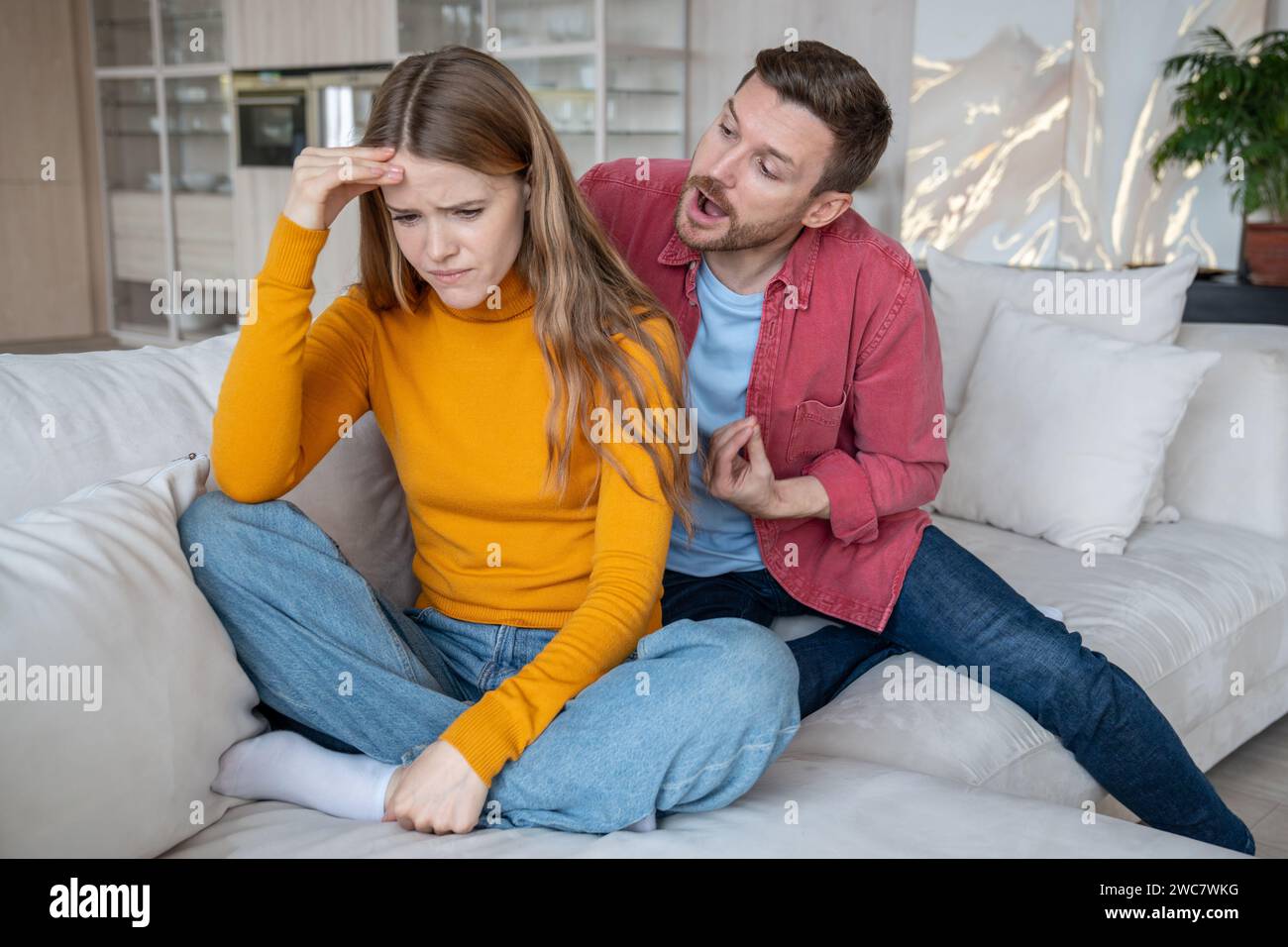 Family quarrel. Jealous husband screaming on upset wife crying sitting ...