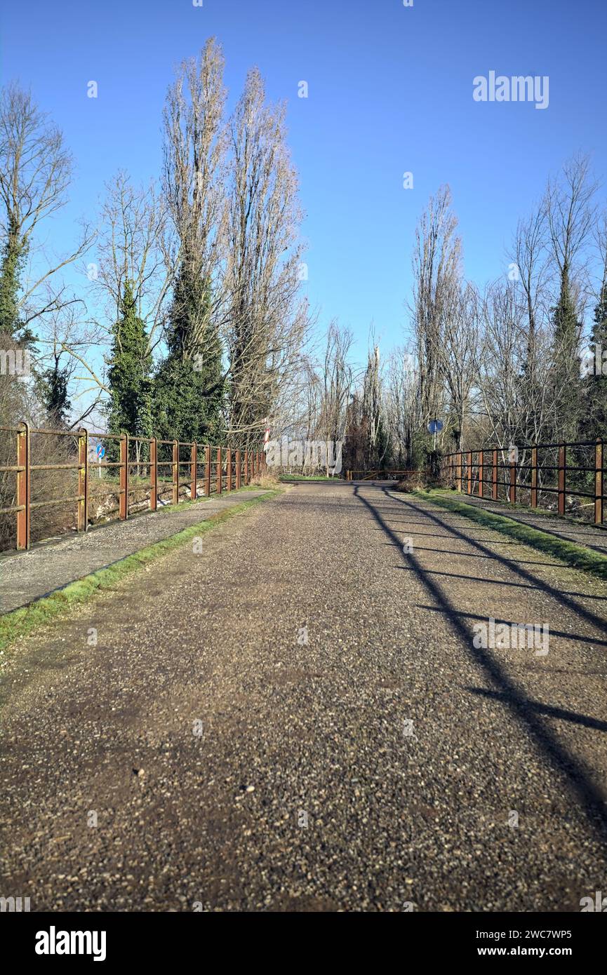 Crossroads between a dirt path and a bridge Stock Photo - Alamy