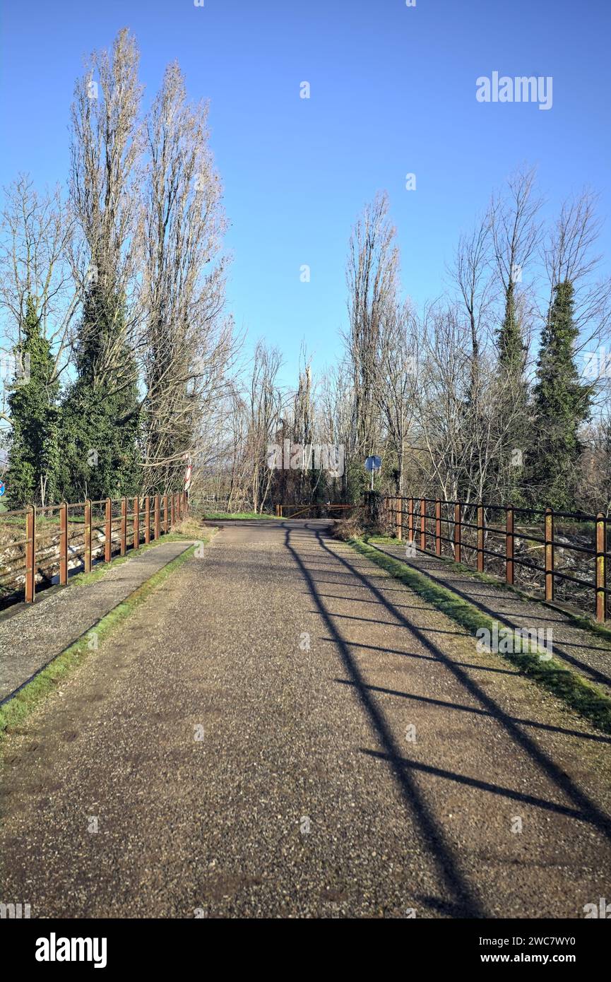Crossroads between a dirt path and a bridge Stock Photo - Alamy