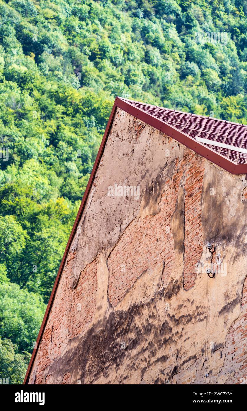 Close up detail with a old medieval red bricks wall. Peeling off ...