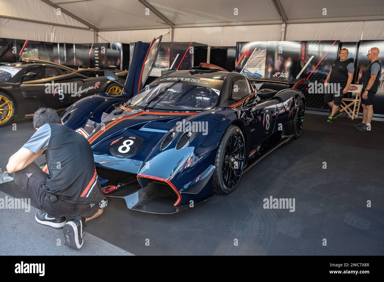 A young guy is cleaning the impressive body of the Pagani Huayra R GT1 ...