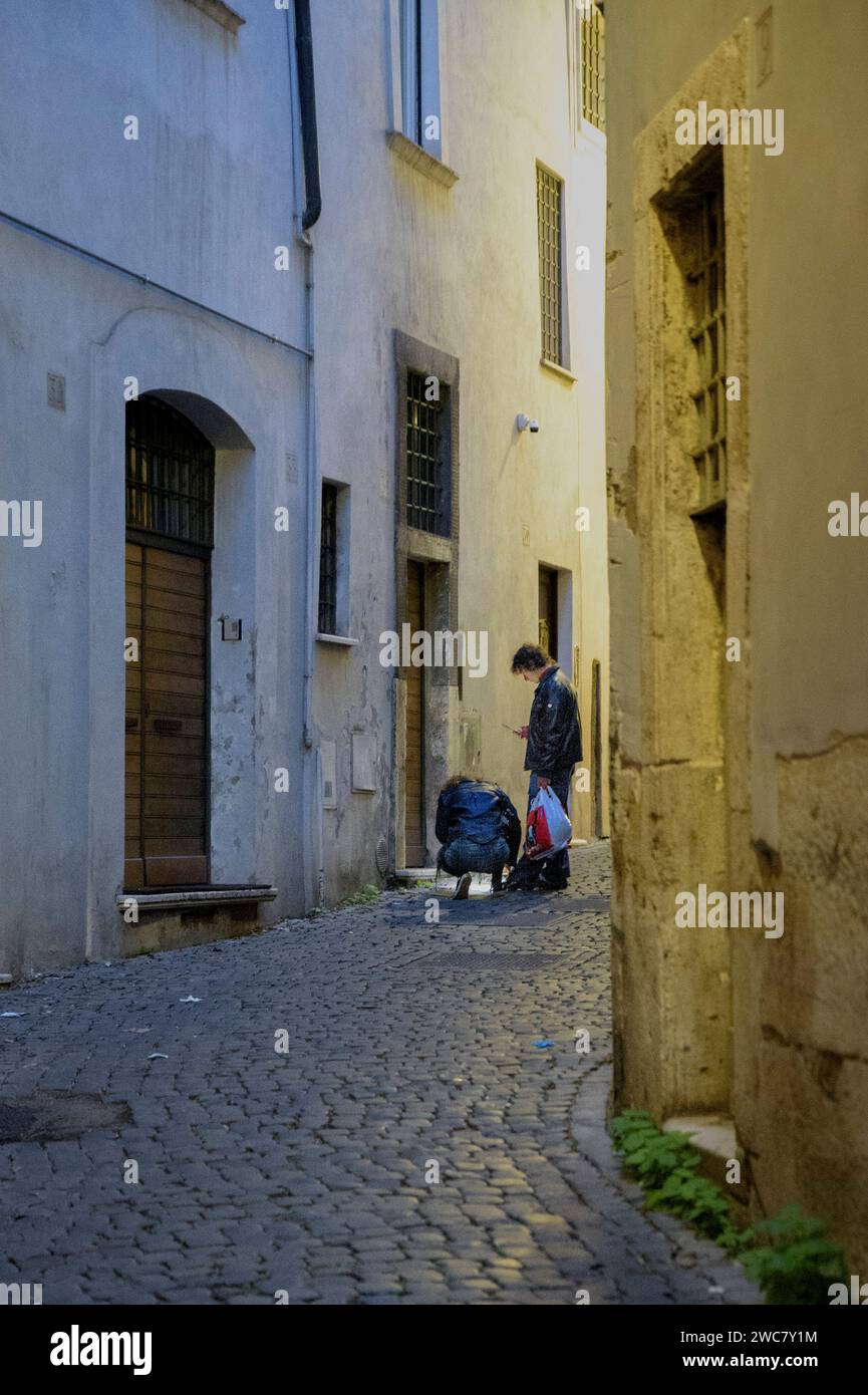 Rome, Italy. 14th Jan, 2024. Two passers-by look with interest at the ...
