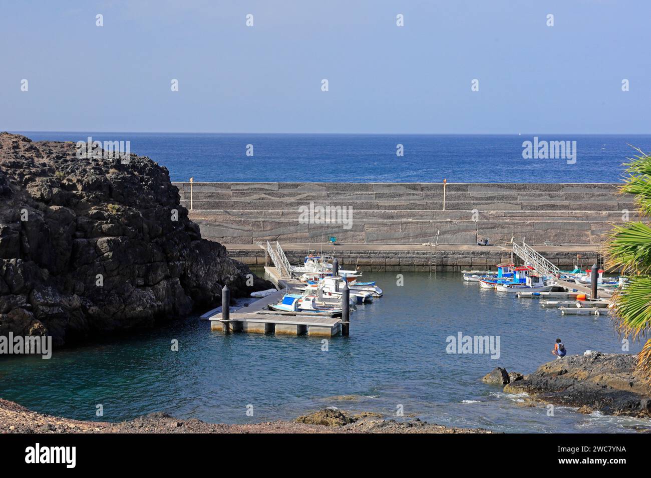 El Cotillo fishing harbour with rocky volcanic coastal landscape ...