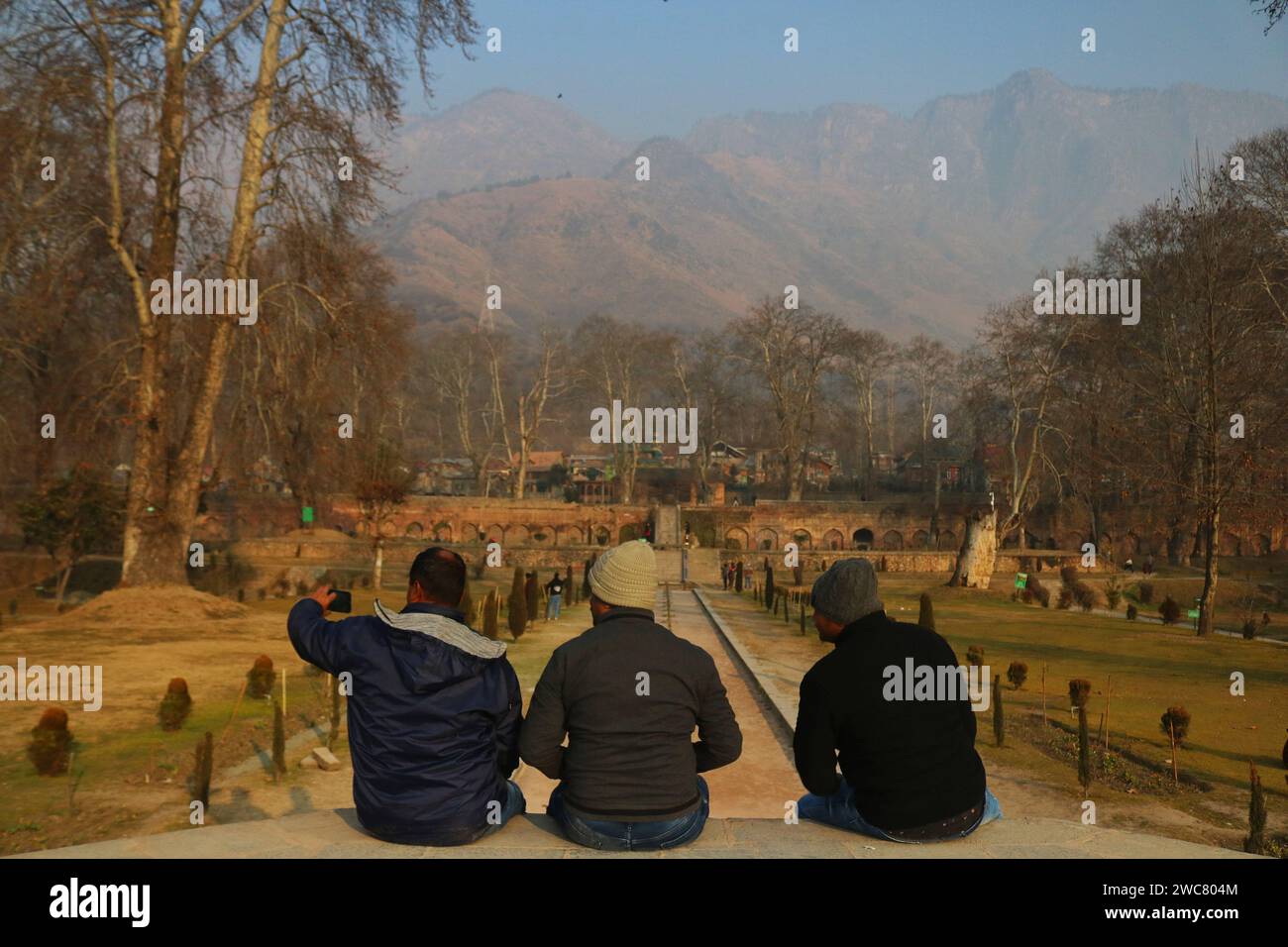 Srinagar Kashmir, India. 14th Jan, 2024. Tourists take selfie pictures at Nishat Garden in ...