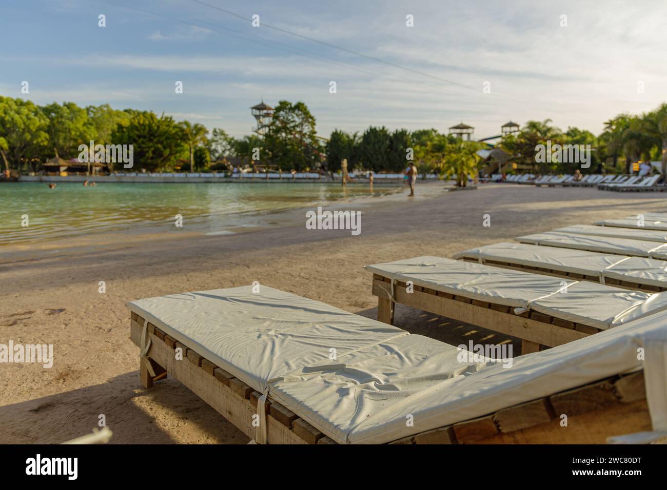 Empty lounge chairs in front of a pool Stock Photo - Alamy