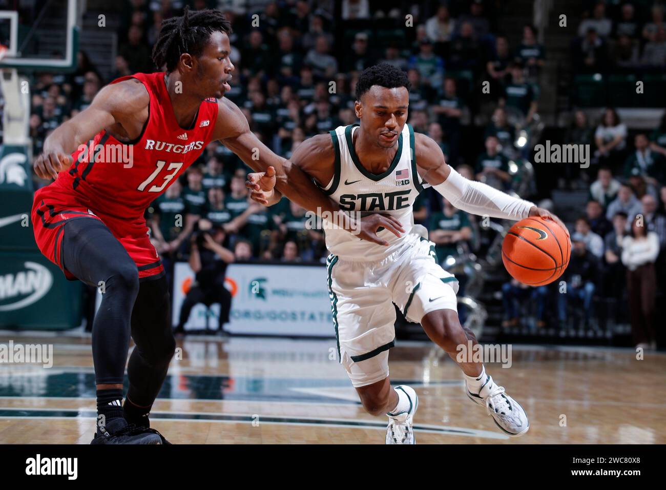 Michigan State guard Tyson Walker, right, drives against Rutgers ...