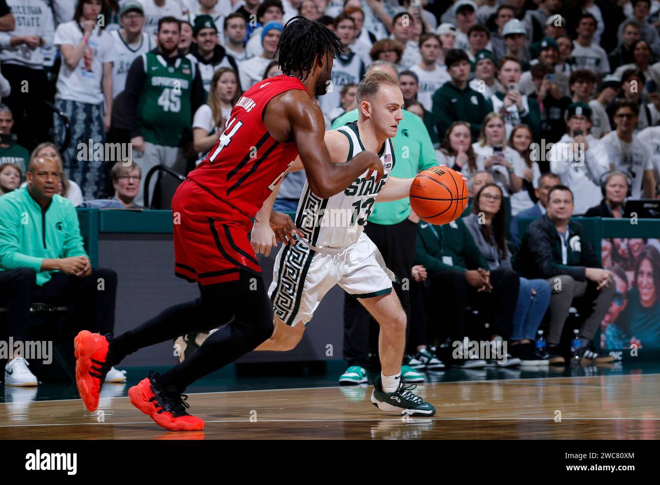 Michigan State guard Steven Izzo (13), right, drives against Rutgers ...