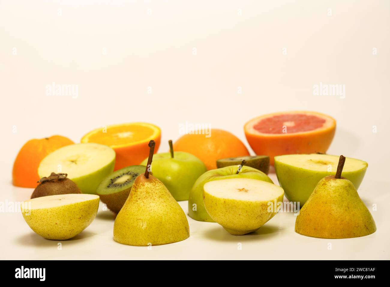 Fresh fruit cut in half isolated on a white background.pear,kiwi,apple ...