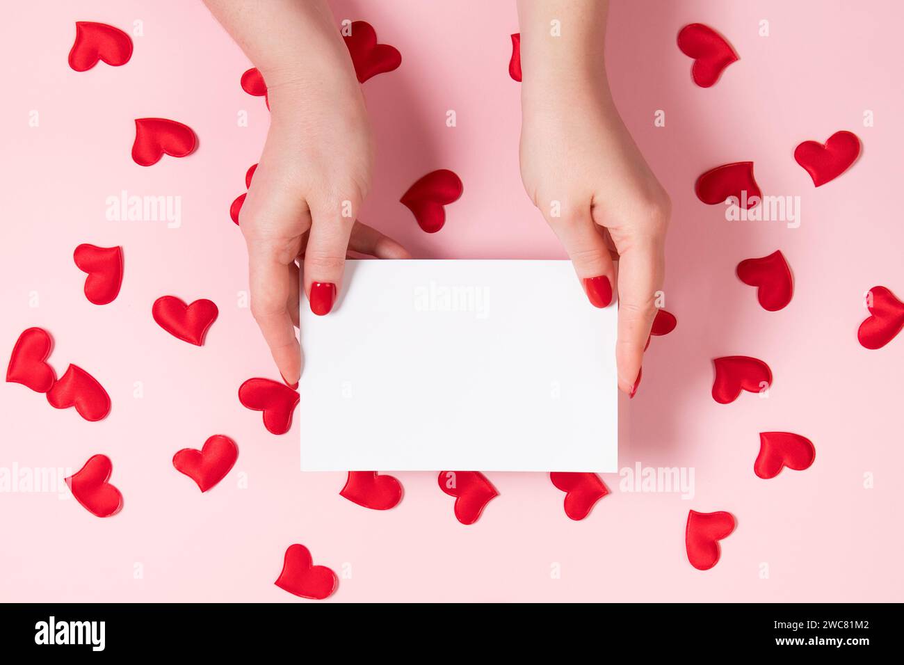 Female hands hold greeting card for valentine's day. Place for your ...