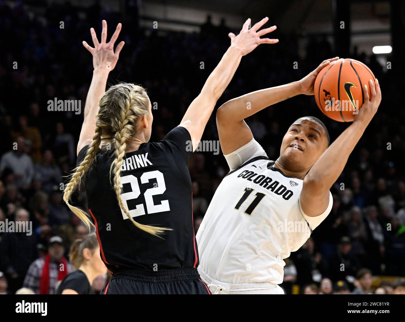 Colorado forward Quay Miller, right, shoots over Stanford forward ...